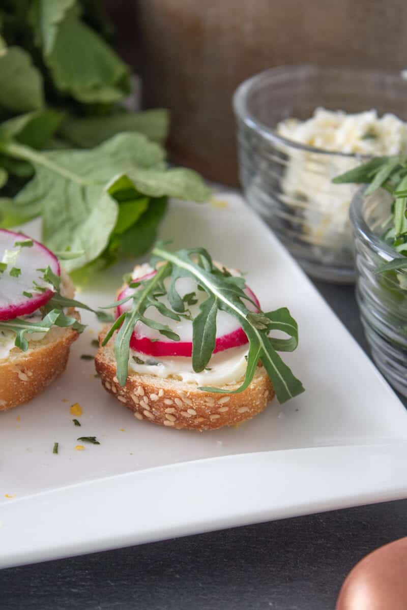 Crostini With Herb Butter And Arugula - The Honeycomb Home